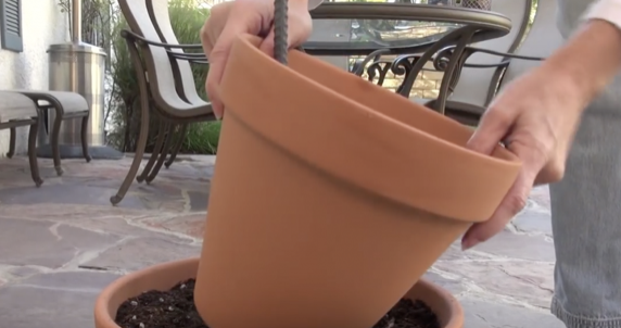 This Woman Stacks Flower Pots Onto a Metal Rod. But When She's Done It ...